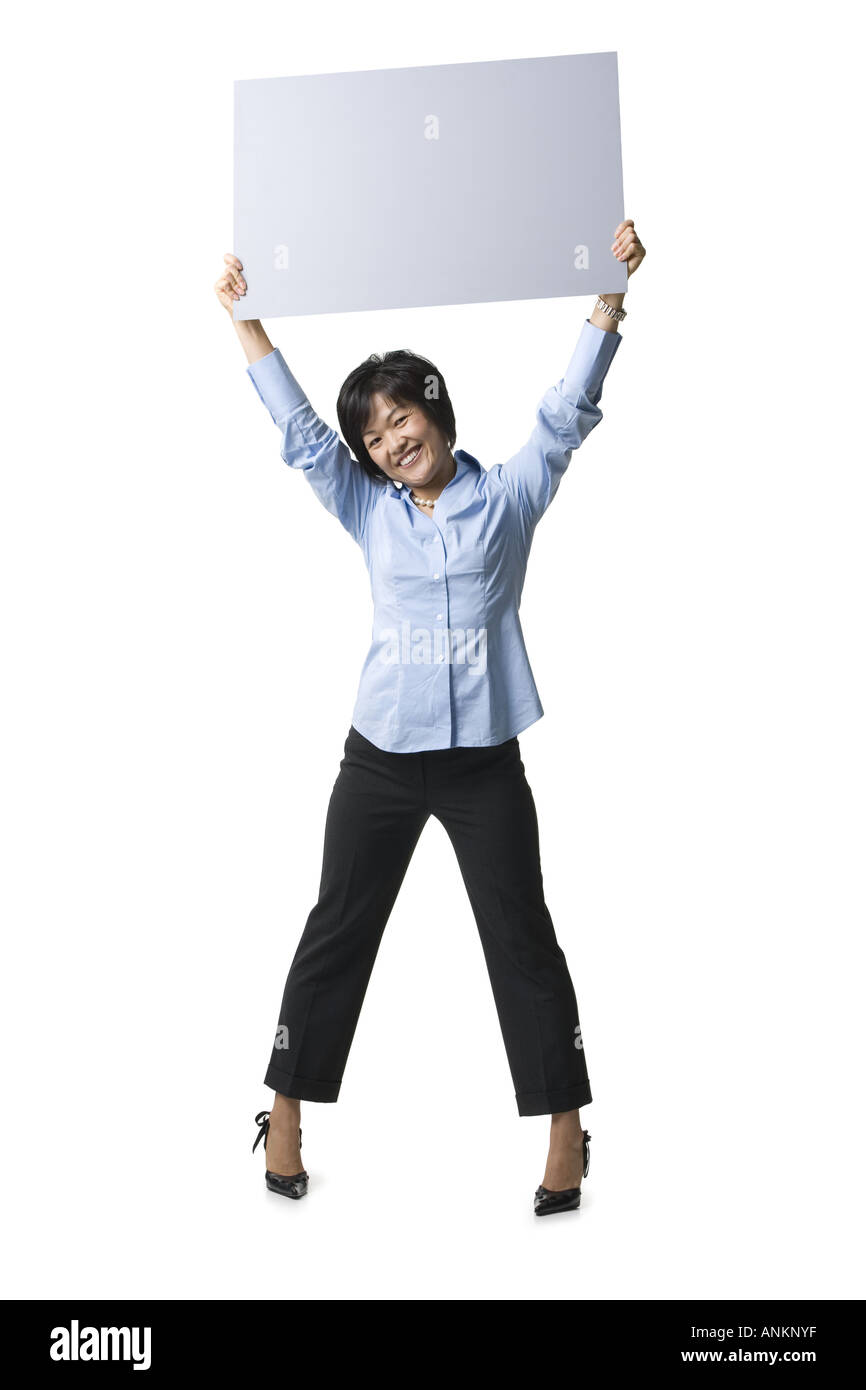 Portrait of a mid adult woman holding up a blank sign Stock Photo - Alamy