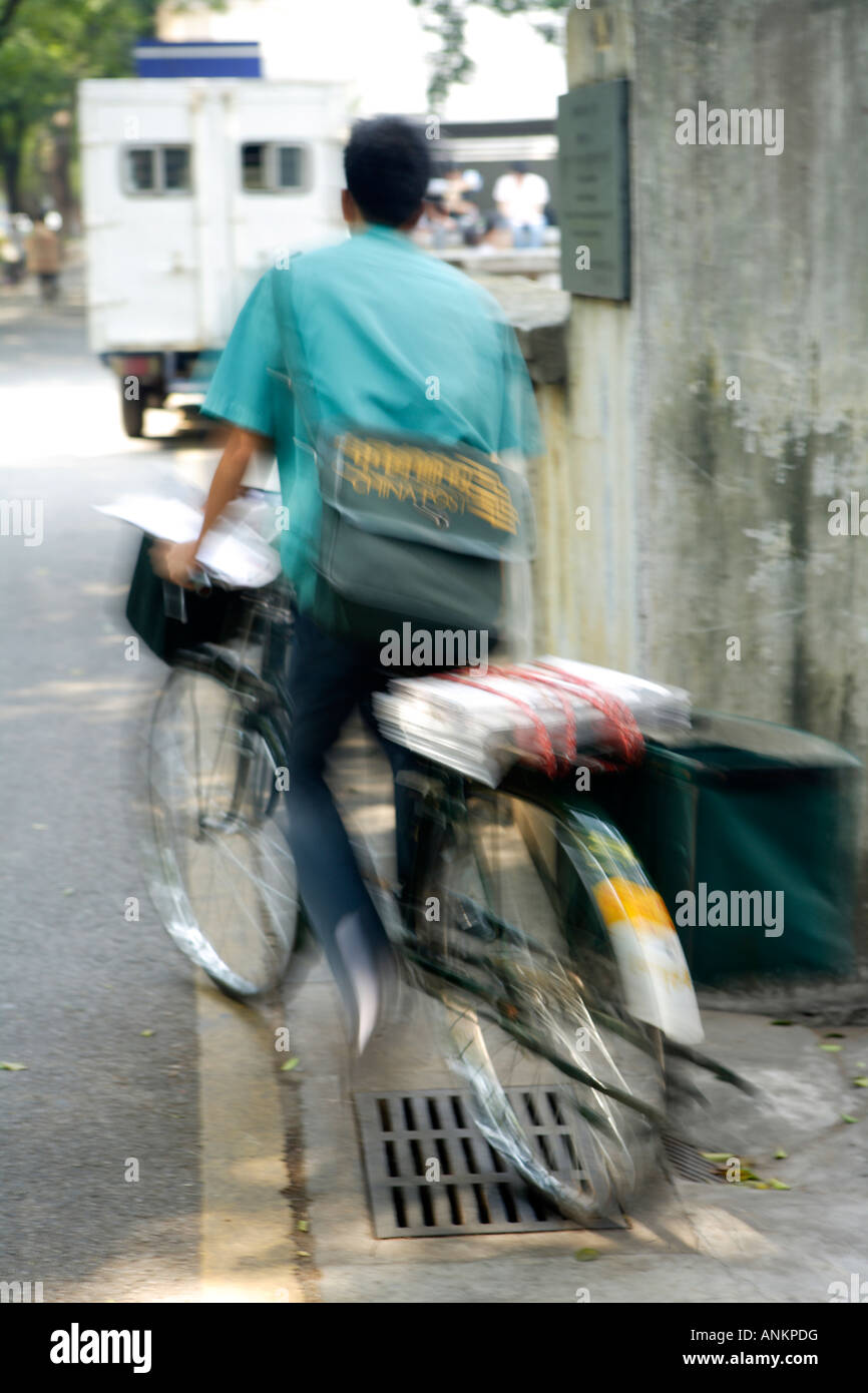 Postman riding bike, Shamian Dao Sand Surface Island, Guangzhou, China ...