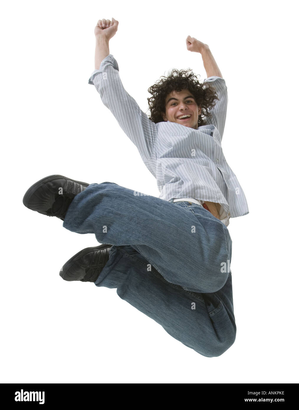 Low angle view of a teenage boy jumping in mid air Stock Photo - Alamy