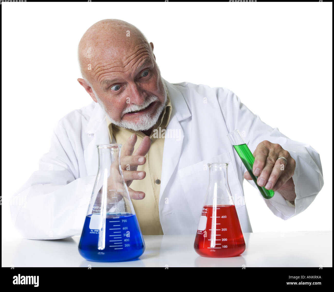 Close up of a male scientist pouring liquid from a test tube into a ...