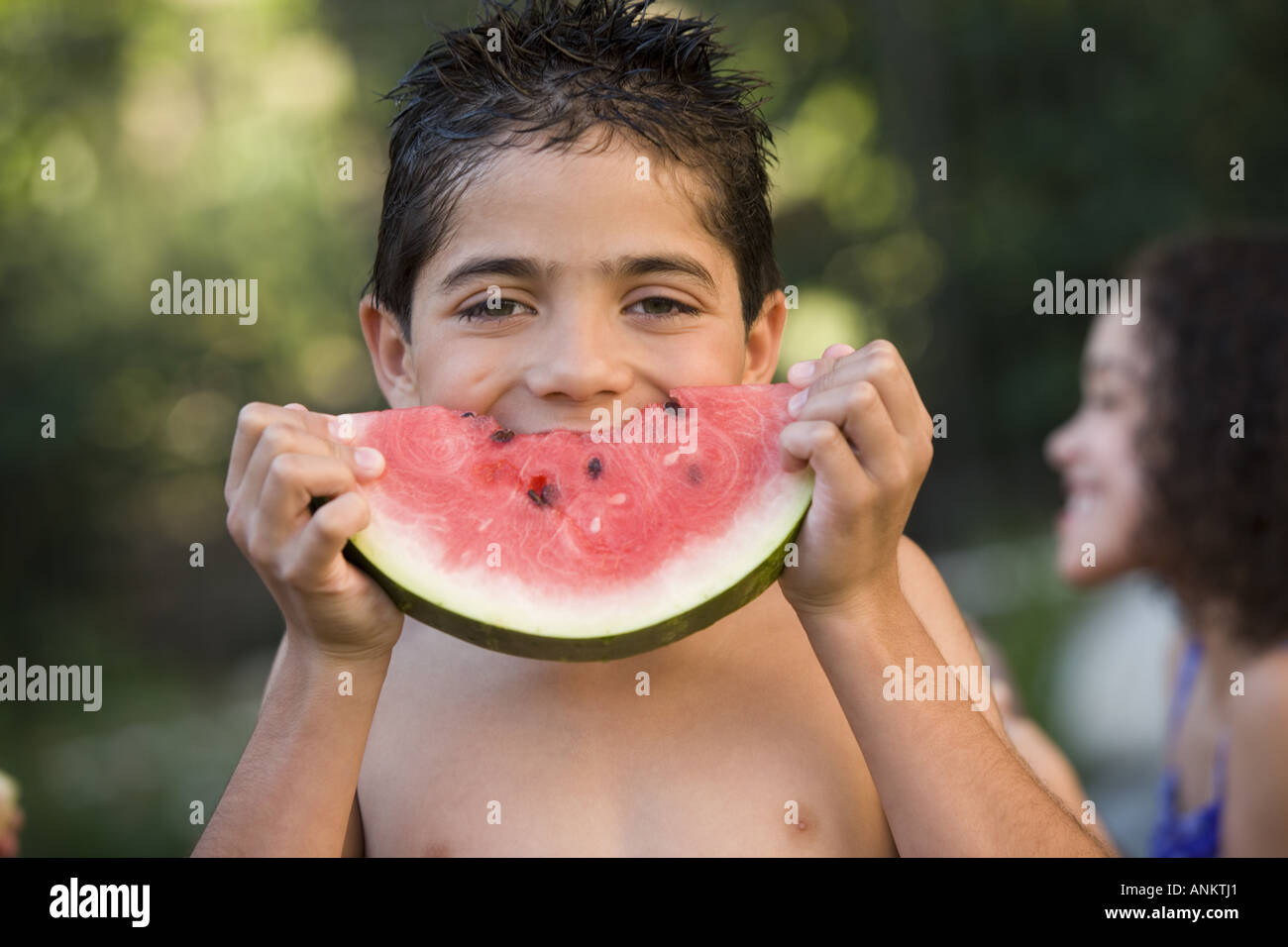 Portrait of a boy eating a watermelon Stock Photo - Alamy