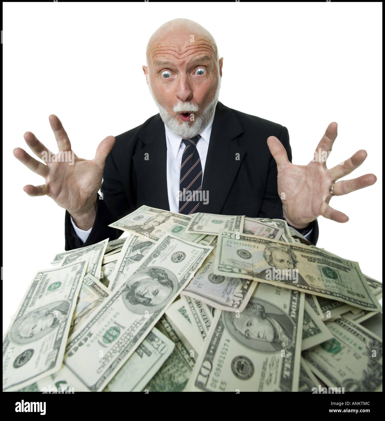 Close up of a businessman looking at a pile of money Stock Photo - Alamy