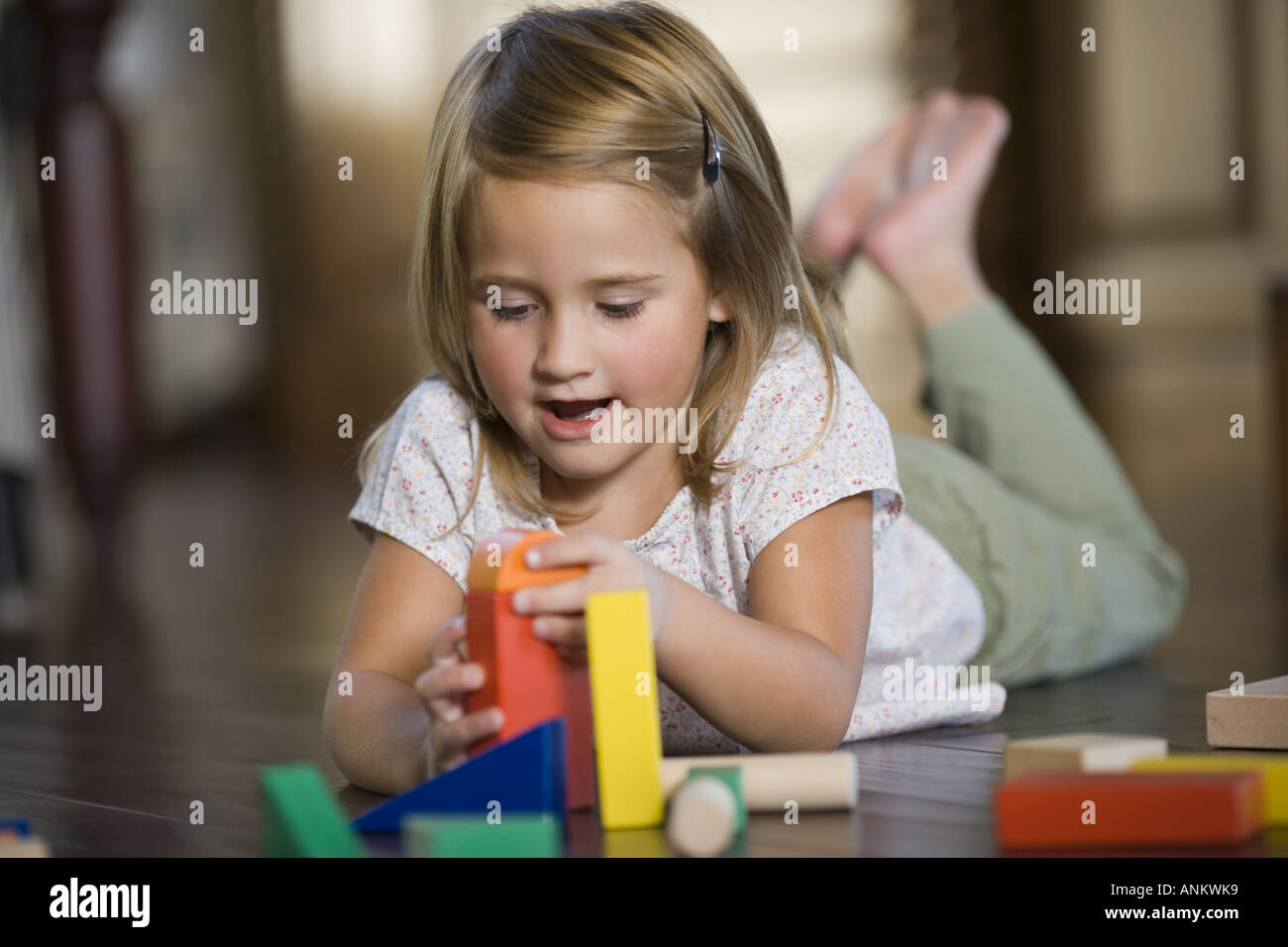 Girl building blocks lying down hi-res stock photography and images - Alamy