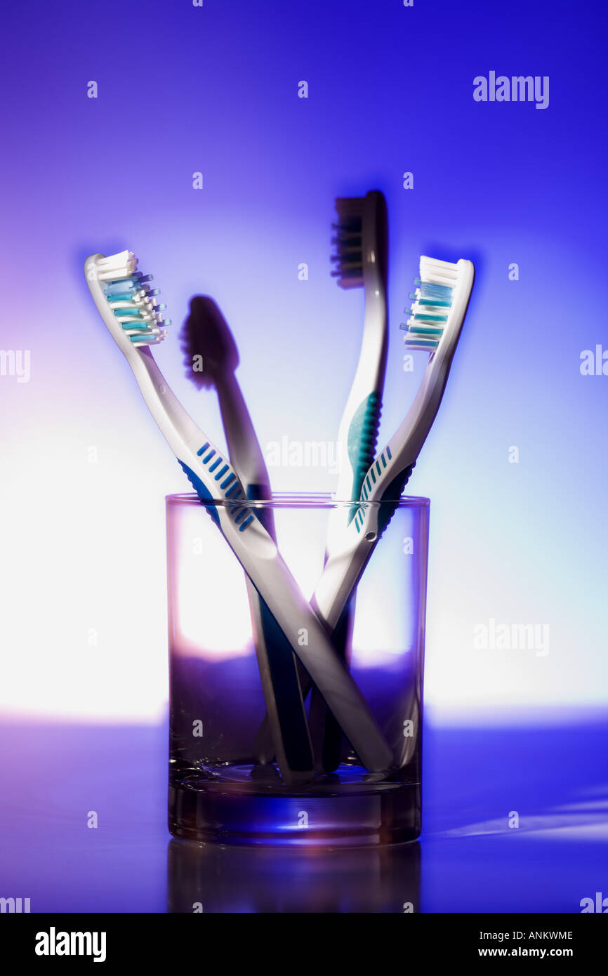 Tooth brushes in cup hi-res stock photography and images - Alamy