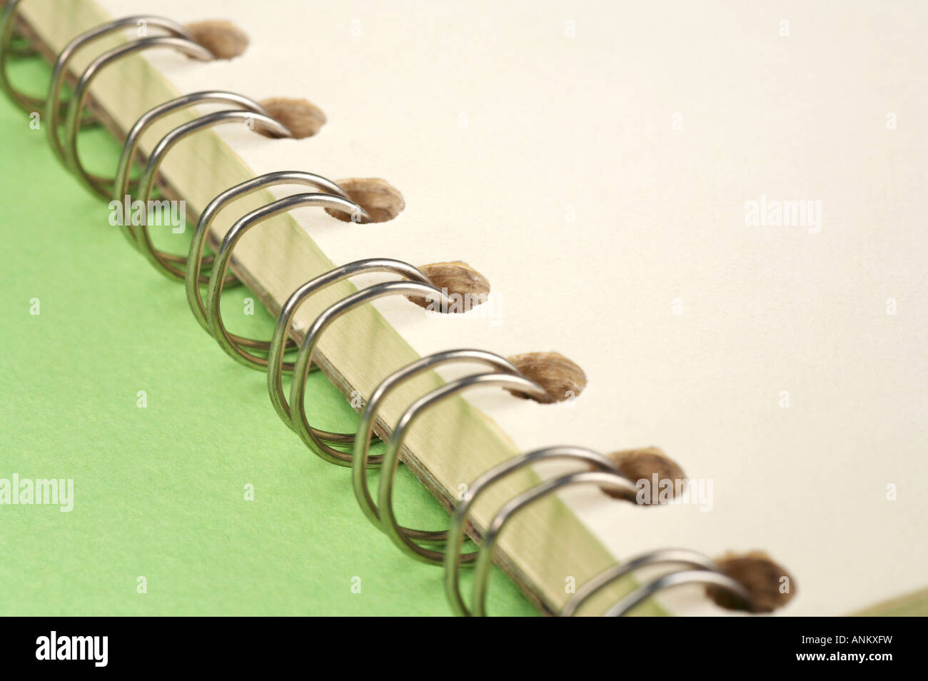 Spiral notebook on green background Stock Photo - Alamy