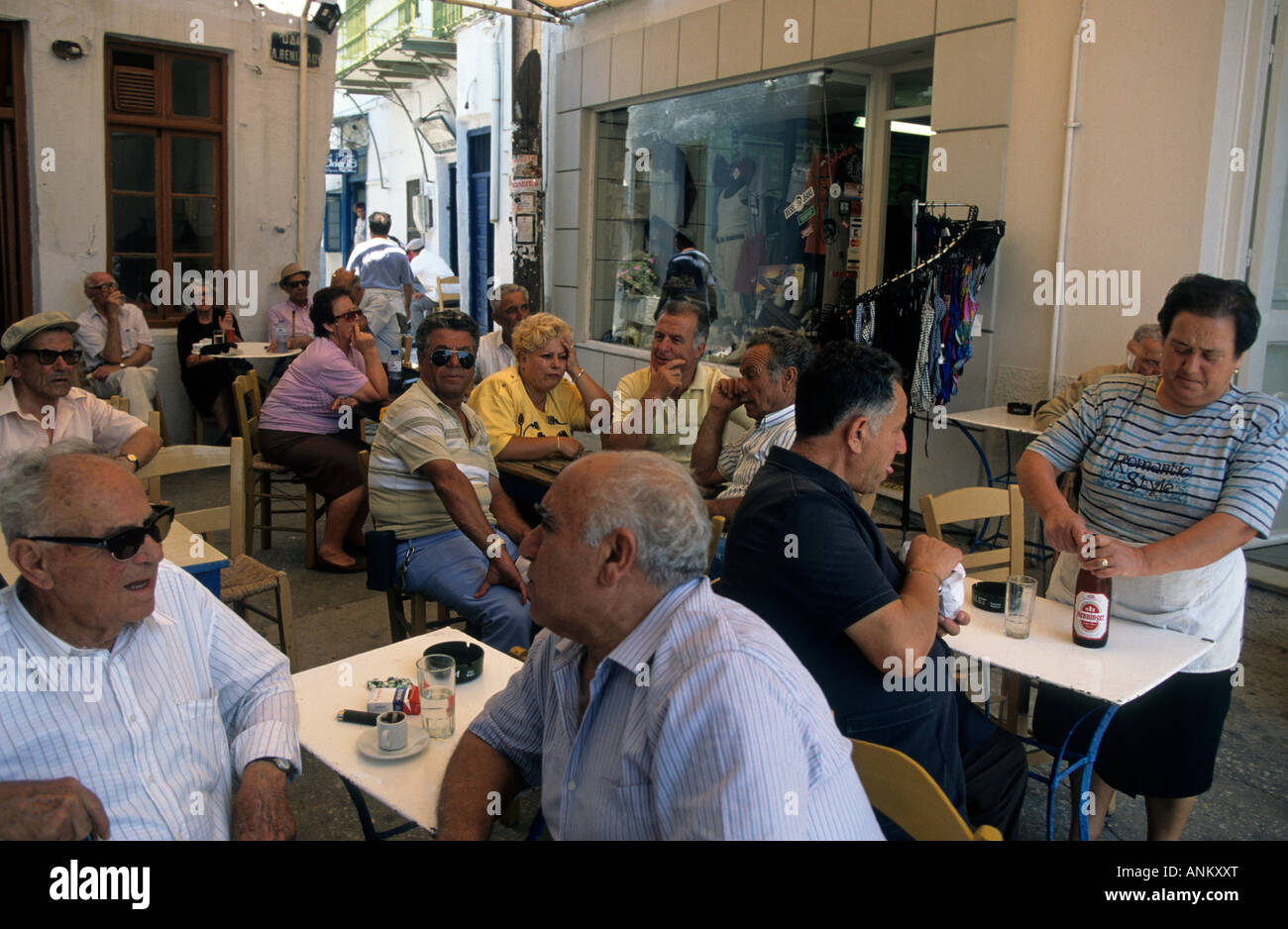 greece northern cyclades tinos a crowded coffee shop in the port Stock ...