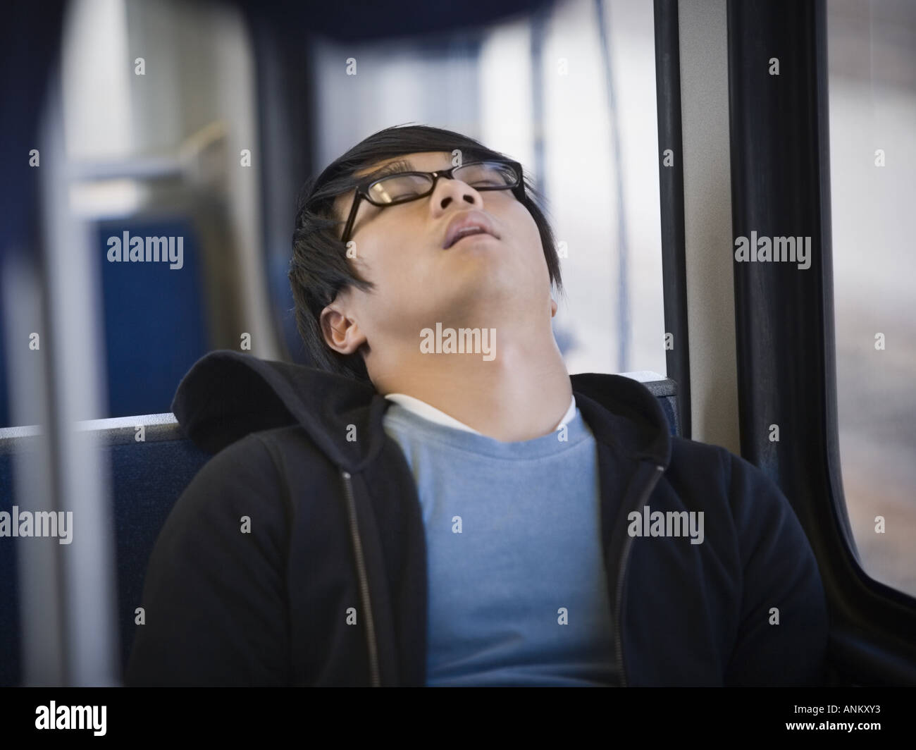 Close up of a young man sleeping on a commuter train Stock Photo - Alamy