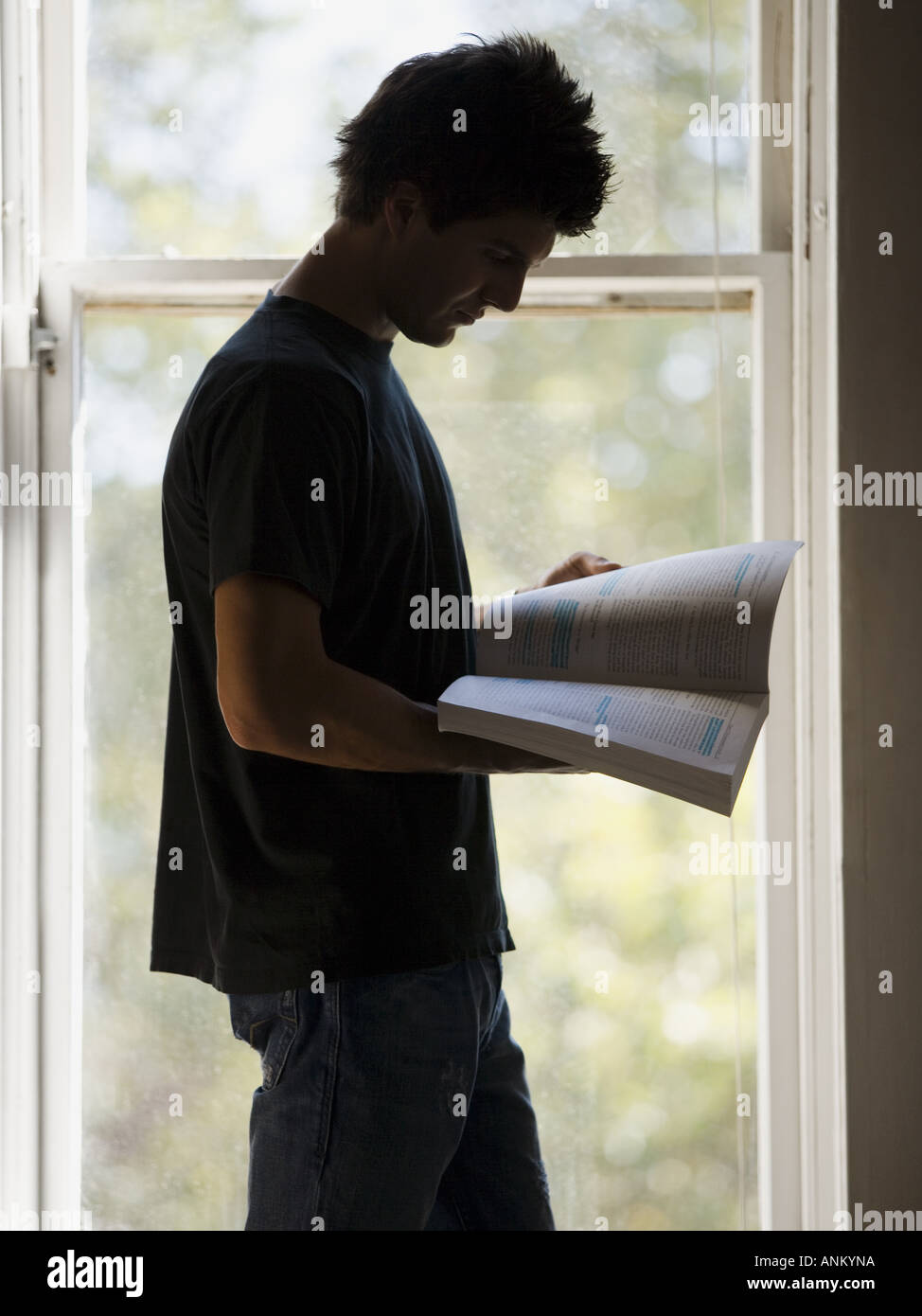Profile of a young man reading a book Stock Photo - Alamy