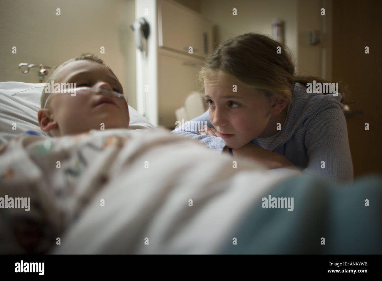 Sister looking at her brother lying in a hospital bed Stock Photo - Alamy