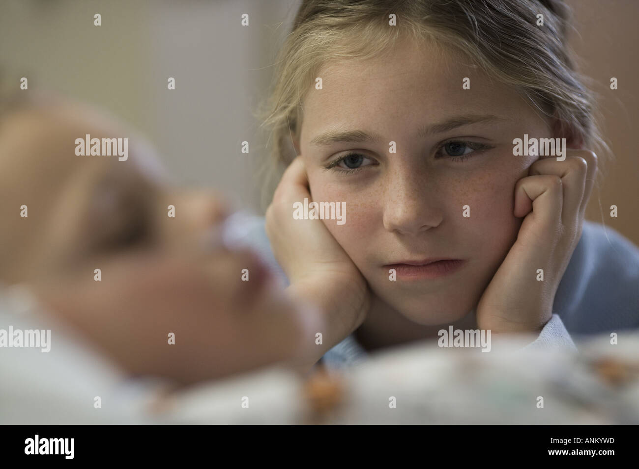 Sister looking at her brother lying in a hospital bed Stock Photo - Alamy