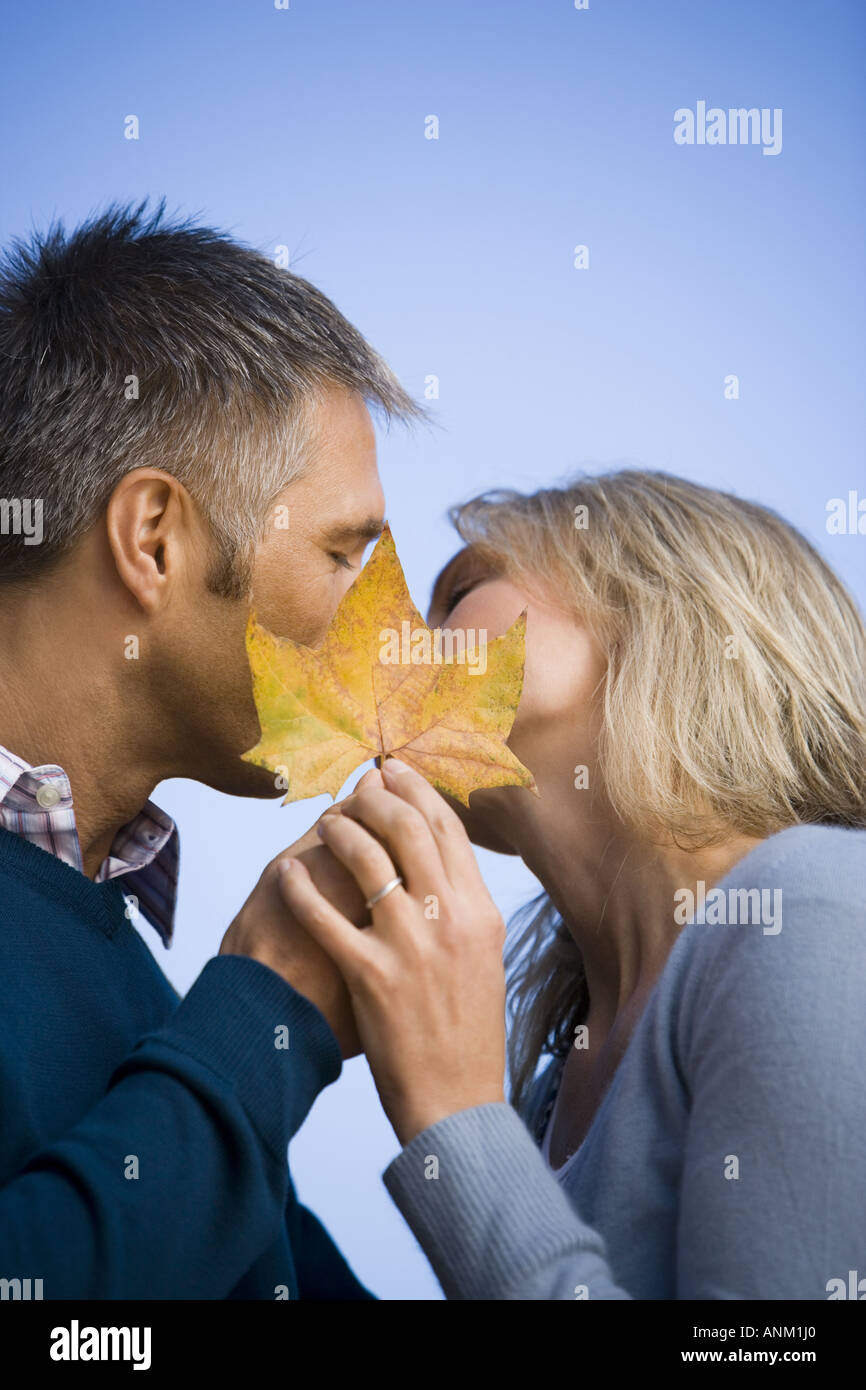 Low angle view of a couple kissing Stock Photo - Alamy