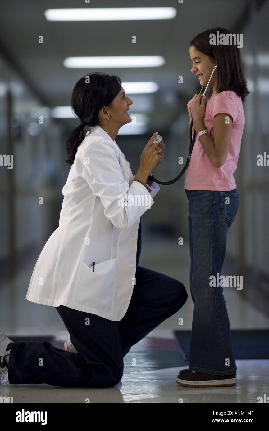 Profile of a female patient checking a female doctor s heart beat Stock ...