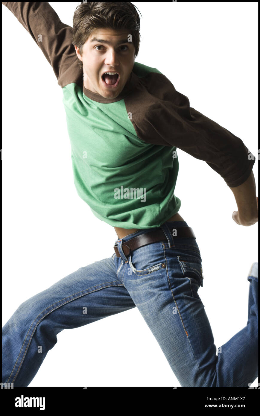Portrait of a young man jumping with his hand raised Stock Photo - Alamy