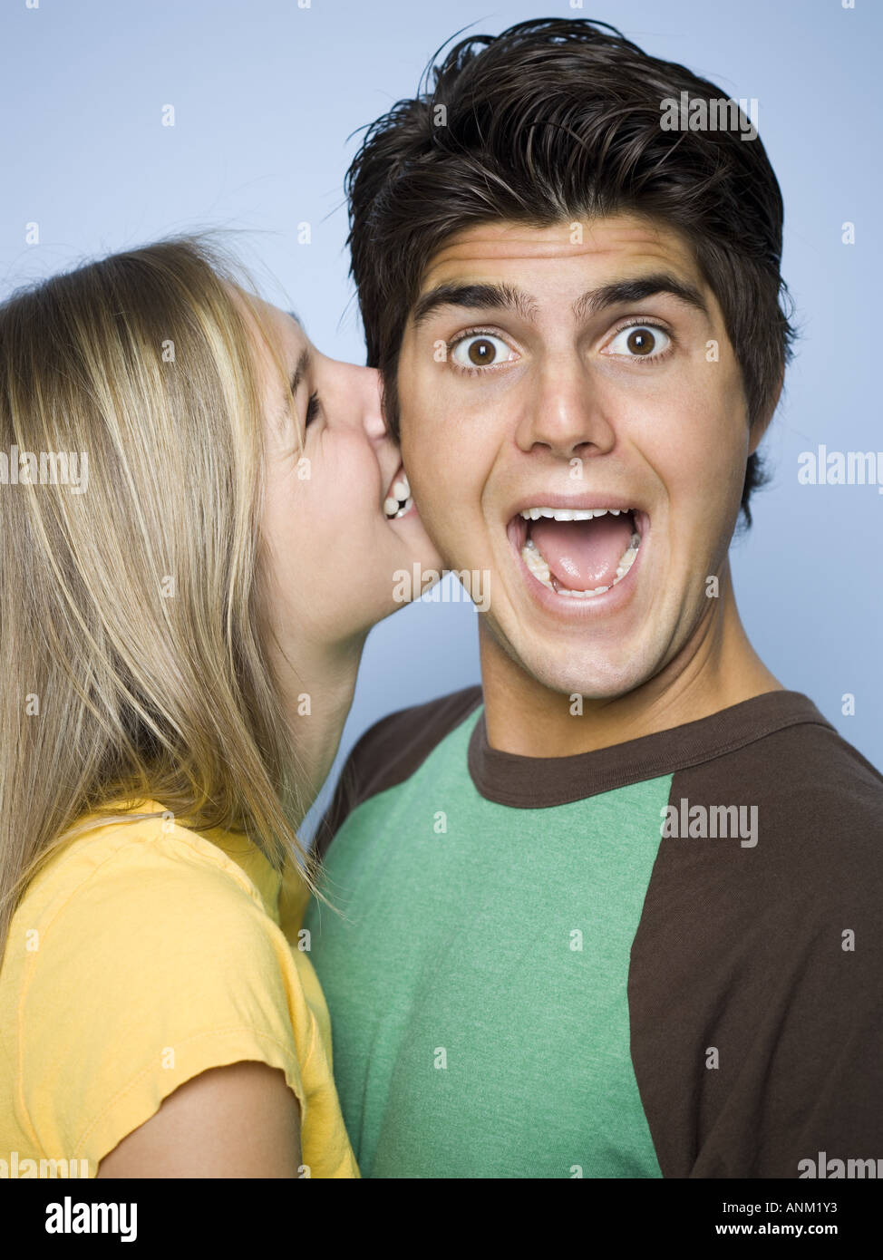Profile of a young woman biting a young man s ear Stock Photo - Alamy