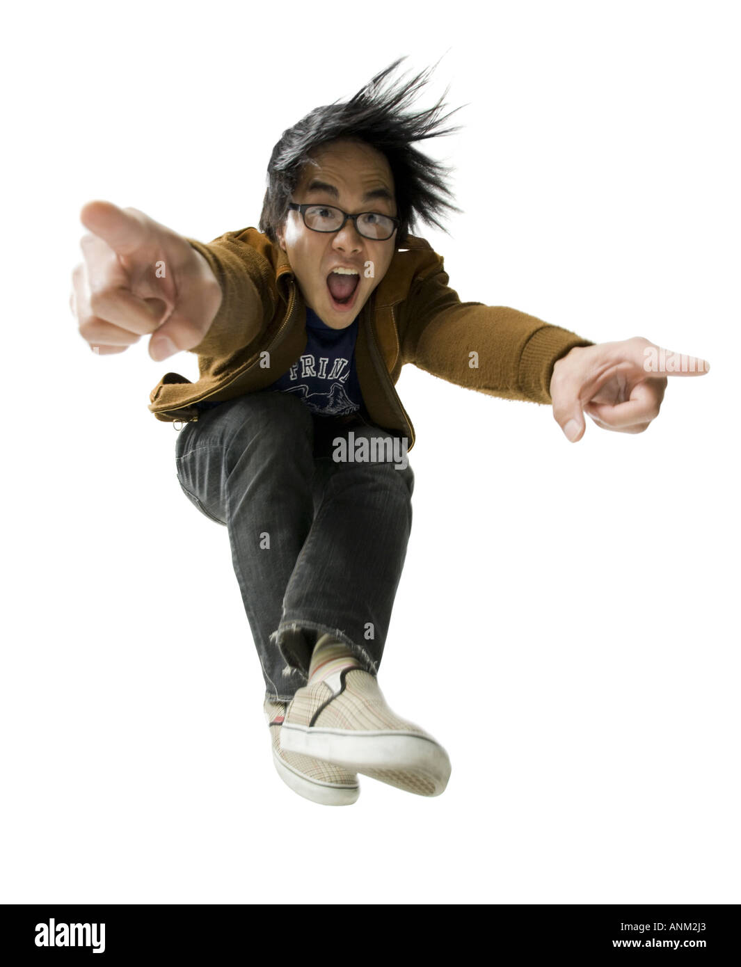 Portrait of a young man jumping and pointing Stock Photo - Alamy