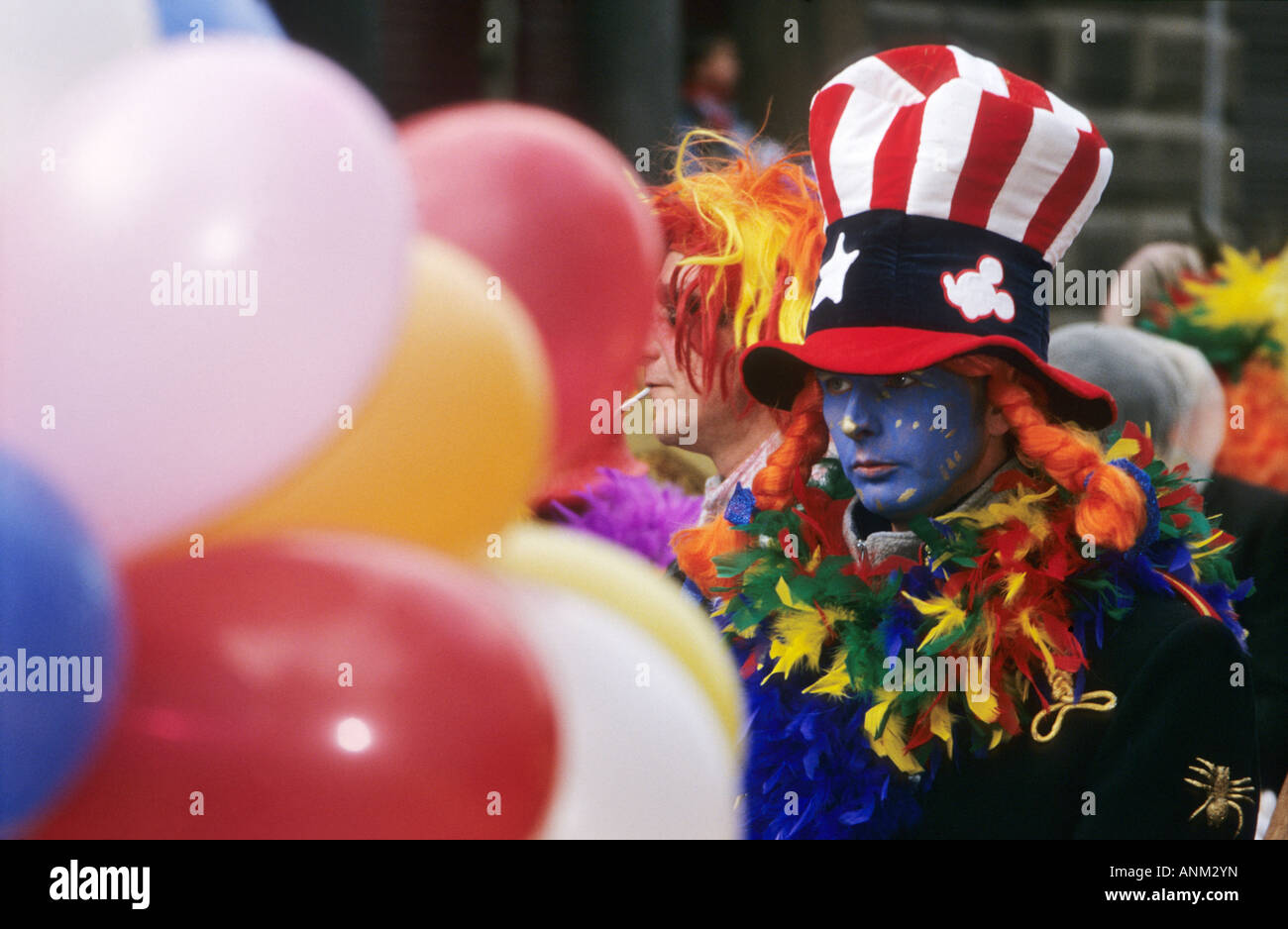 young man in fancy dress among balloons at annual carnival parade in ...