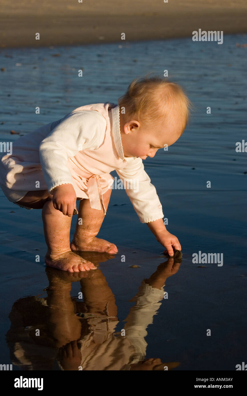 little girl exploring on the beach Stock Photo - Alamy