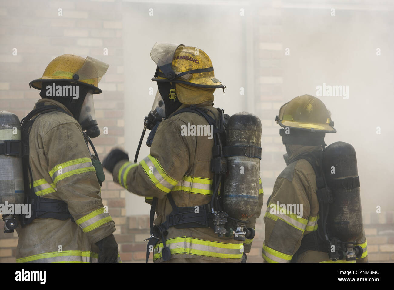 Three firefighters in firefighting gear Stock Photo - Alamy