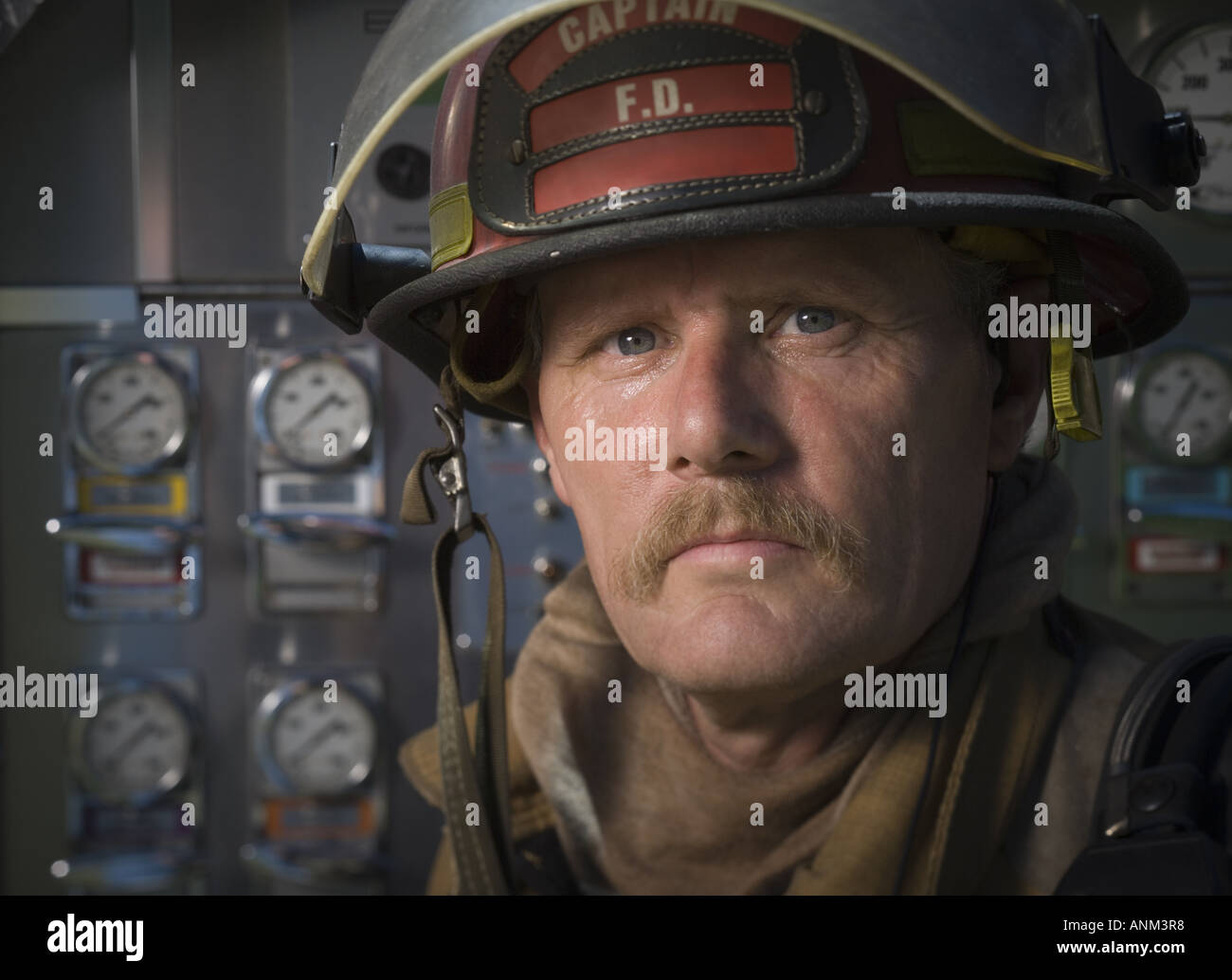 Portrait of a firefighter standing in front of a fire engine Stock ...