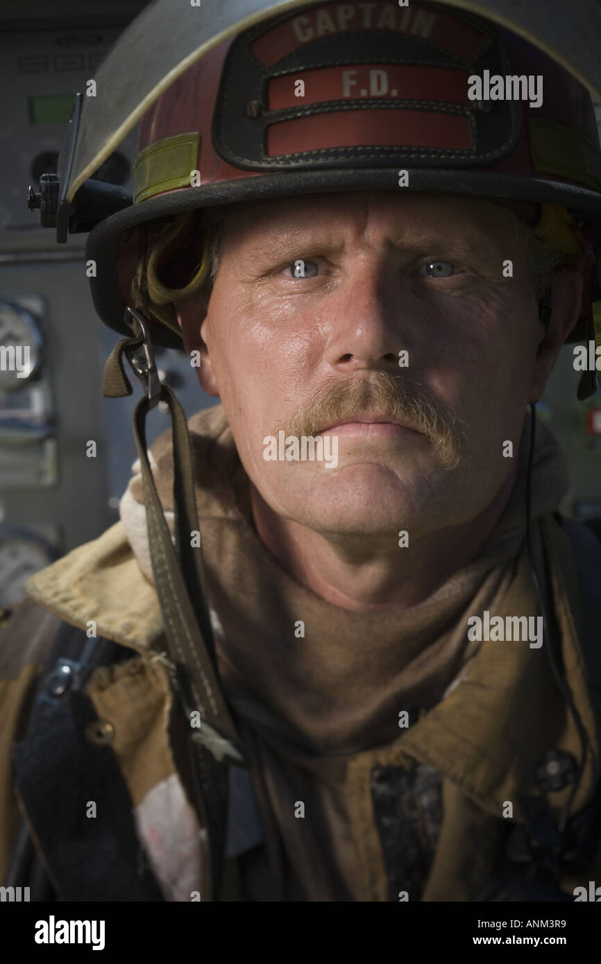 Portrait of a firefighter standing in front of a fire engine Stock ...