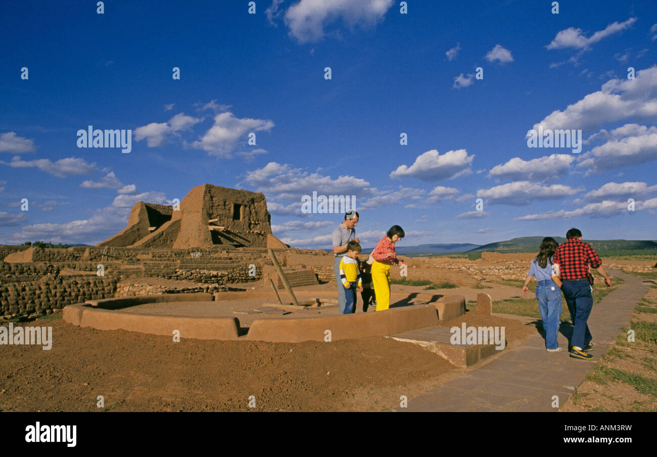 Visitors explore the adobe ruins of an old Spanish mission and an ...