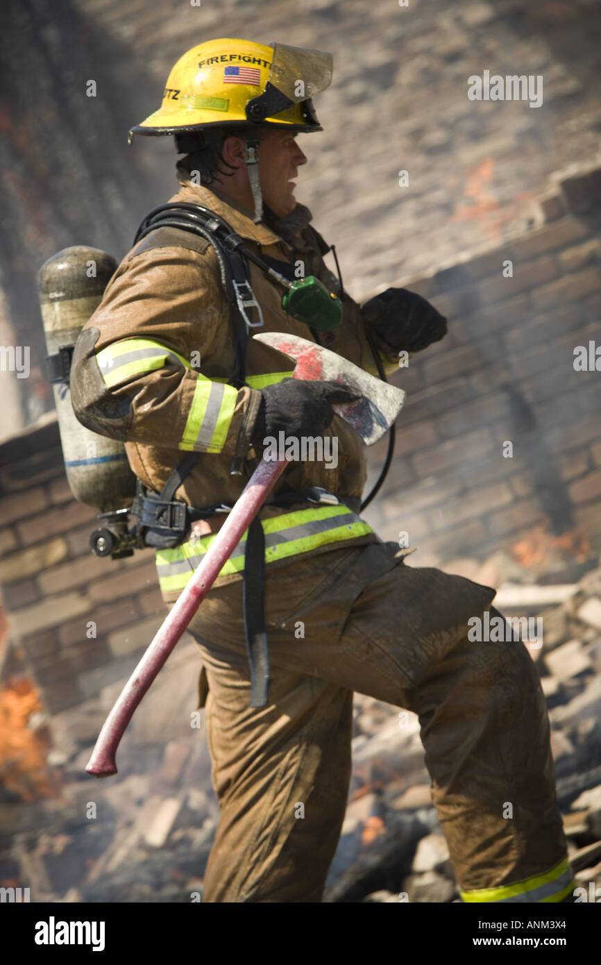 Side profile firefighter holding axe hi-res stock photography and ...