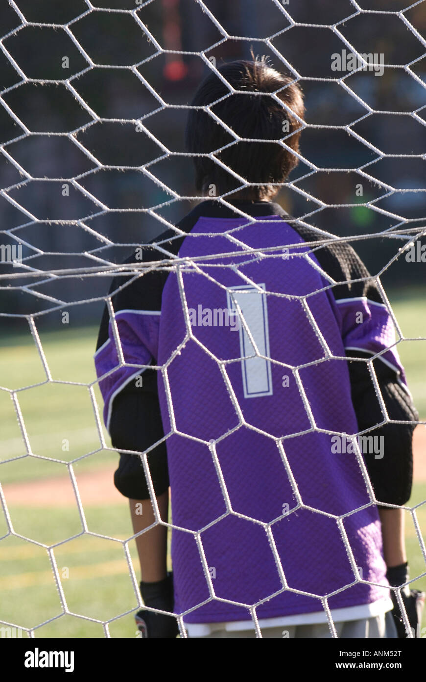 young boy playing soccer protecting net Stock Photo - Alamy