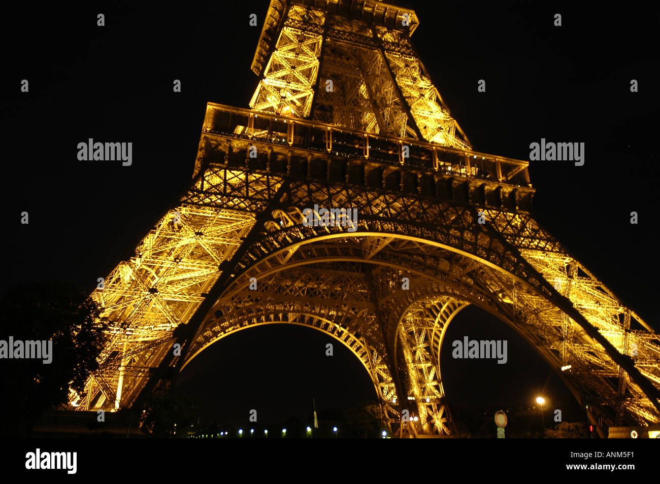 The illuminated Eiffel Tower seen from its base Stock Photo - Alamy