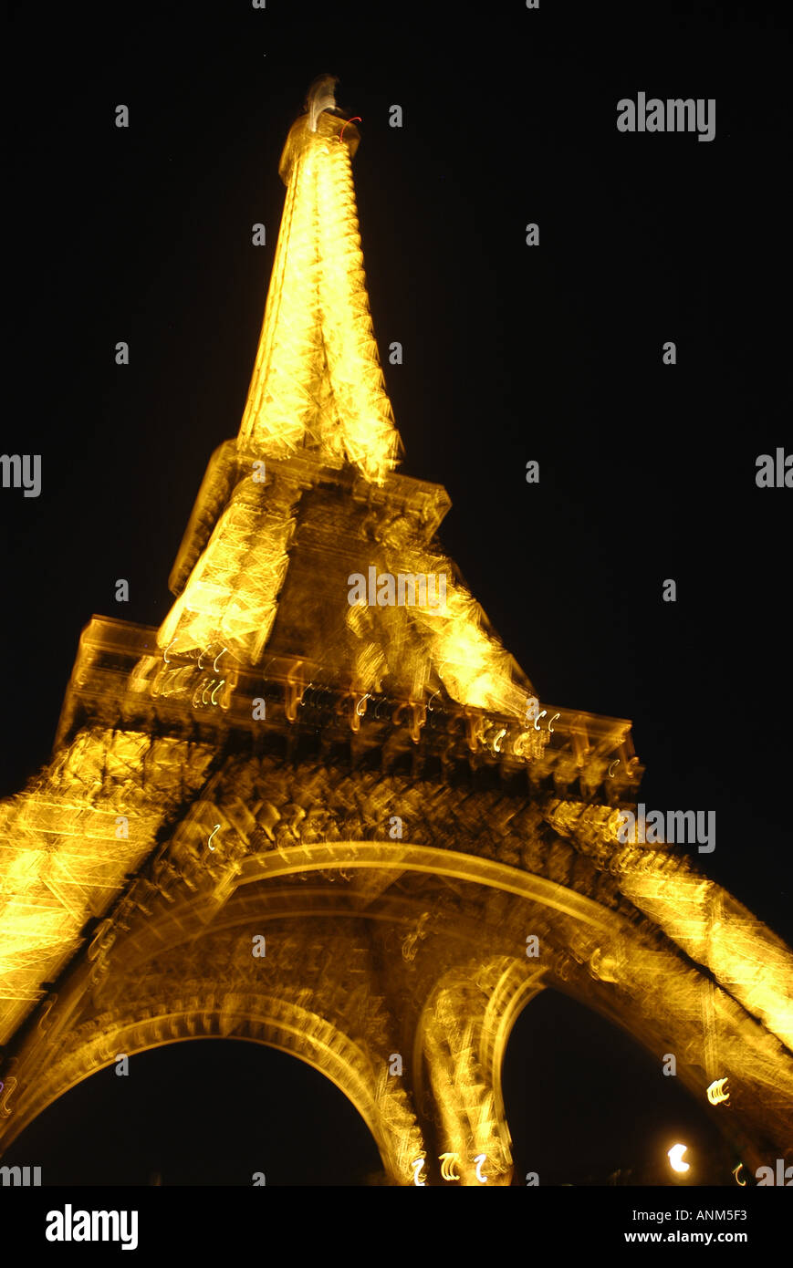 The illuminated Eiffel Tower seen from its base Stock Photo - Alamy