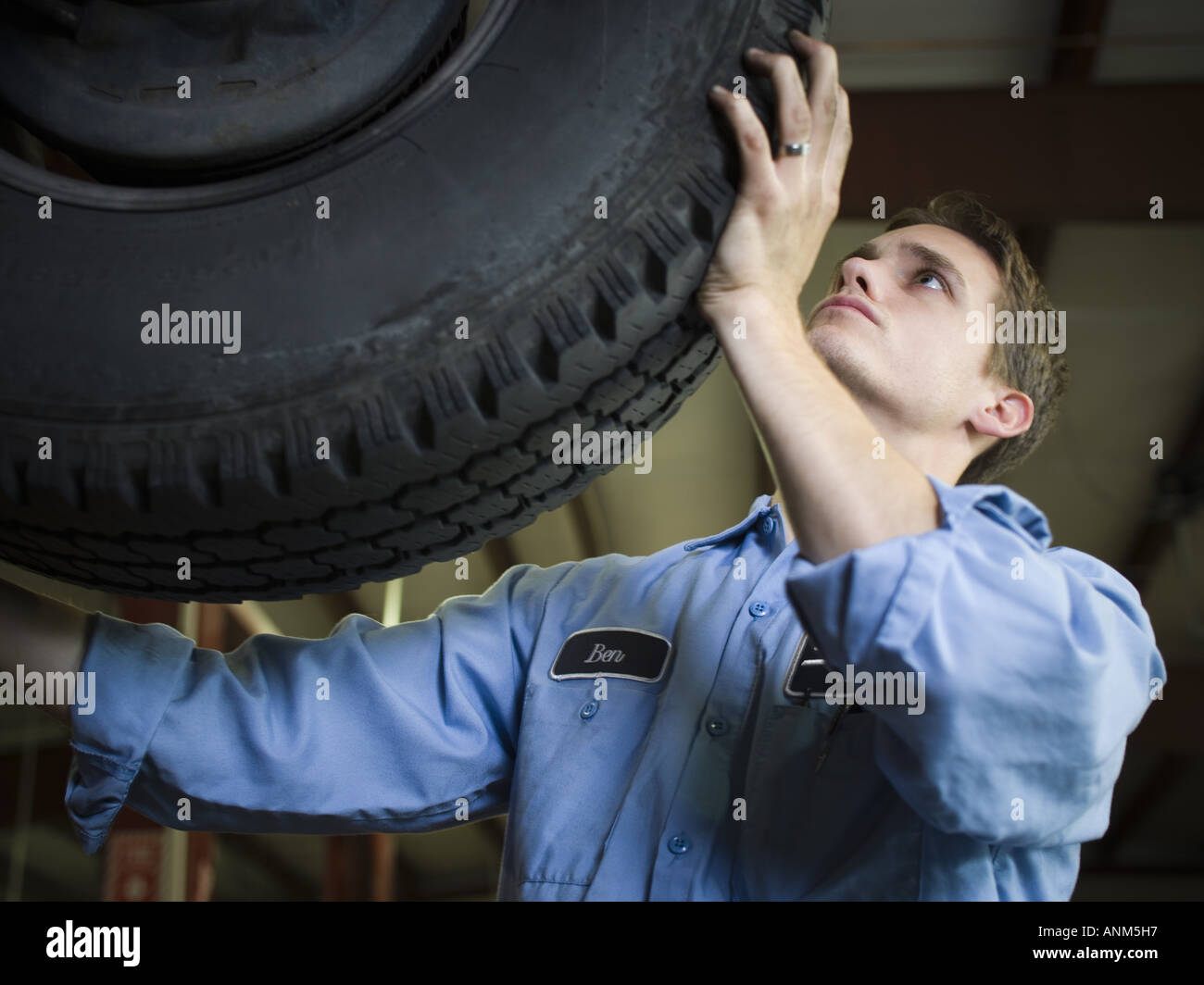 Close up of a man holding the tire of a car hi-res stock photography ...