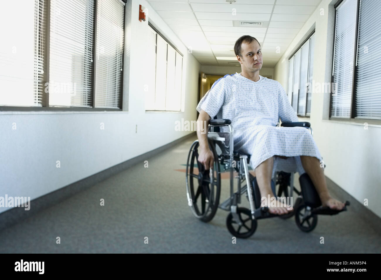 Patient sitting on a wheelchair in a hospital Stock Photo - Alamy