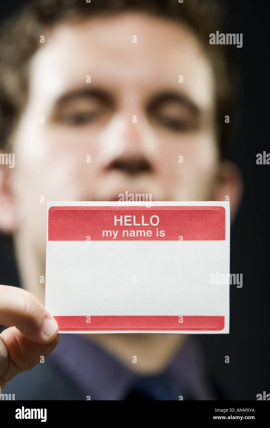 Portrait of a businessman holding a name tag Stock Photo - Alamy
