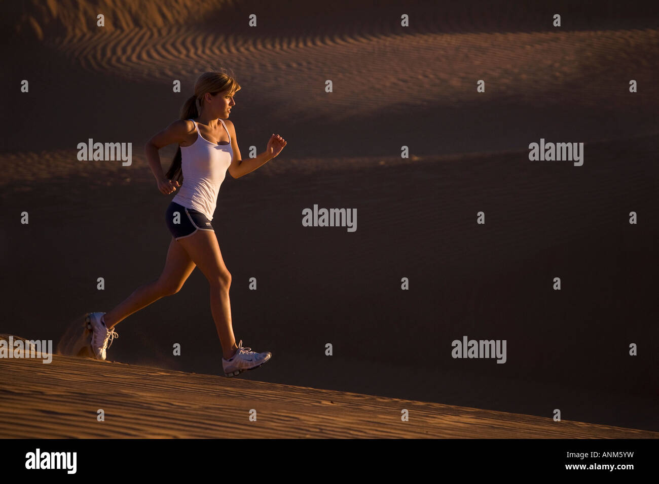 Girl walking on a sand dune hi-res stock photography and images - Alamy