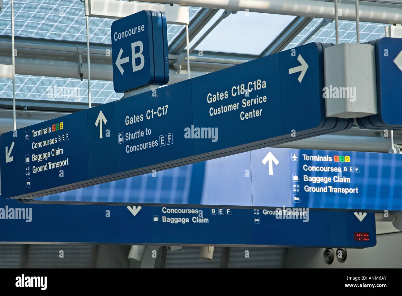 Airport directional signs leading passengers to buildings gates and ...