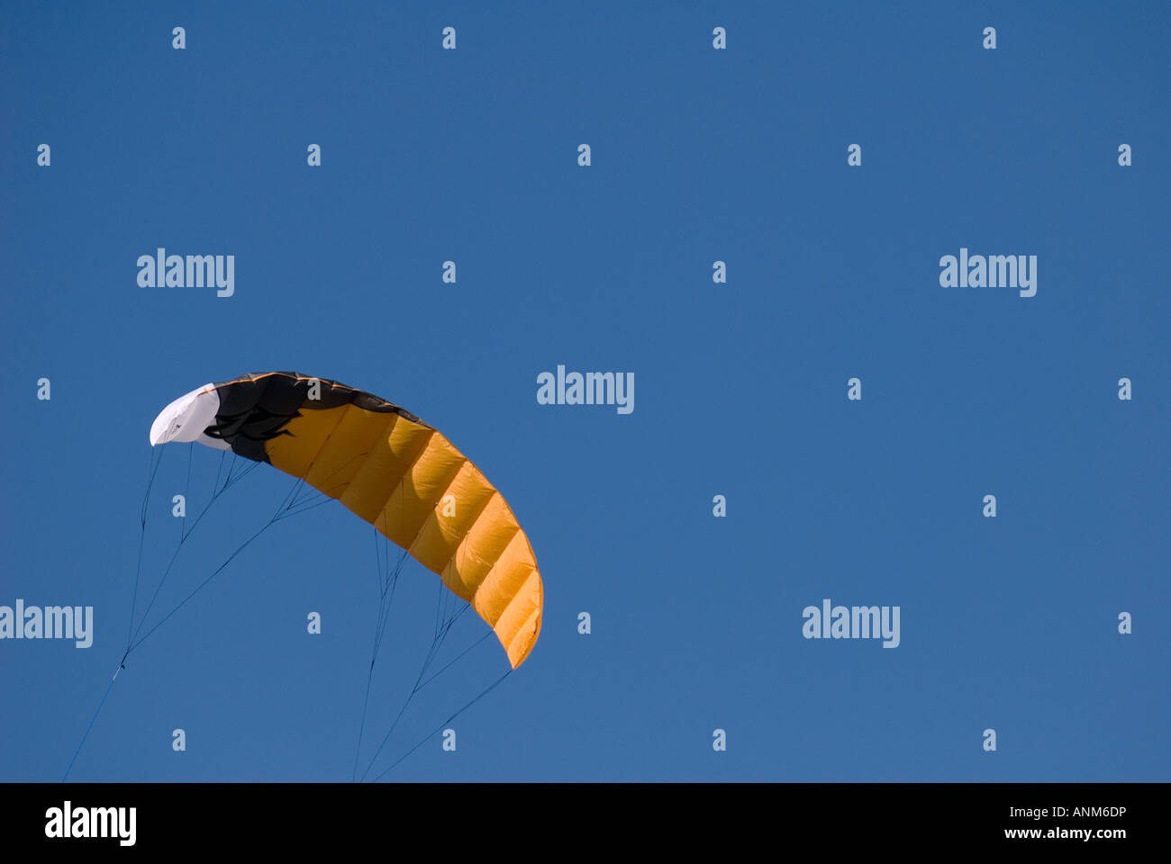 yellow kite flying in blue sky Stock Photo - Alamy