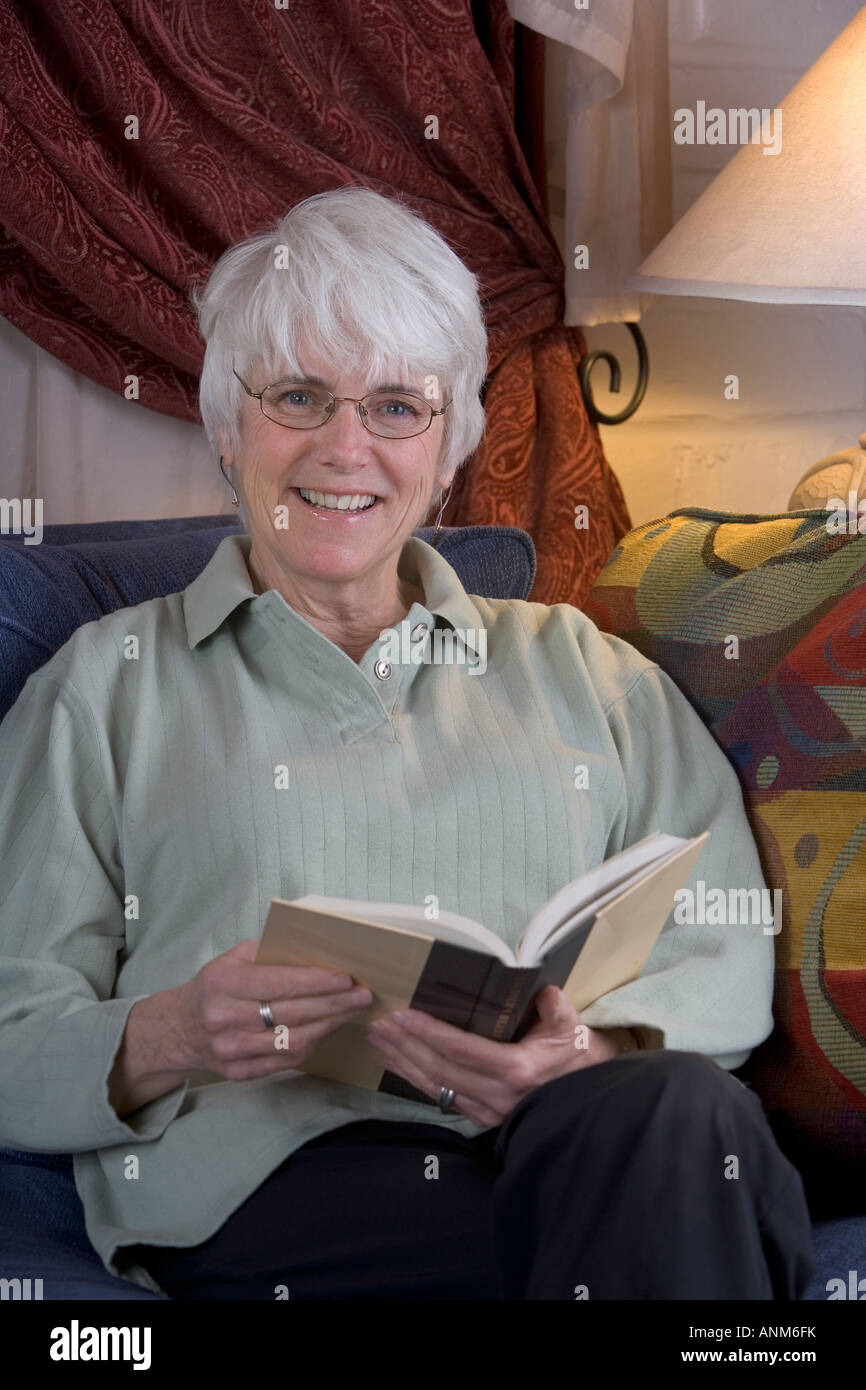 Senior woman reading a book at home Stock Photo - Alamy