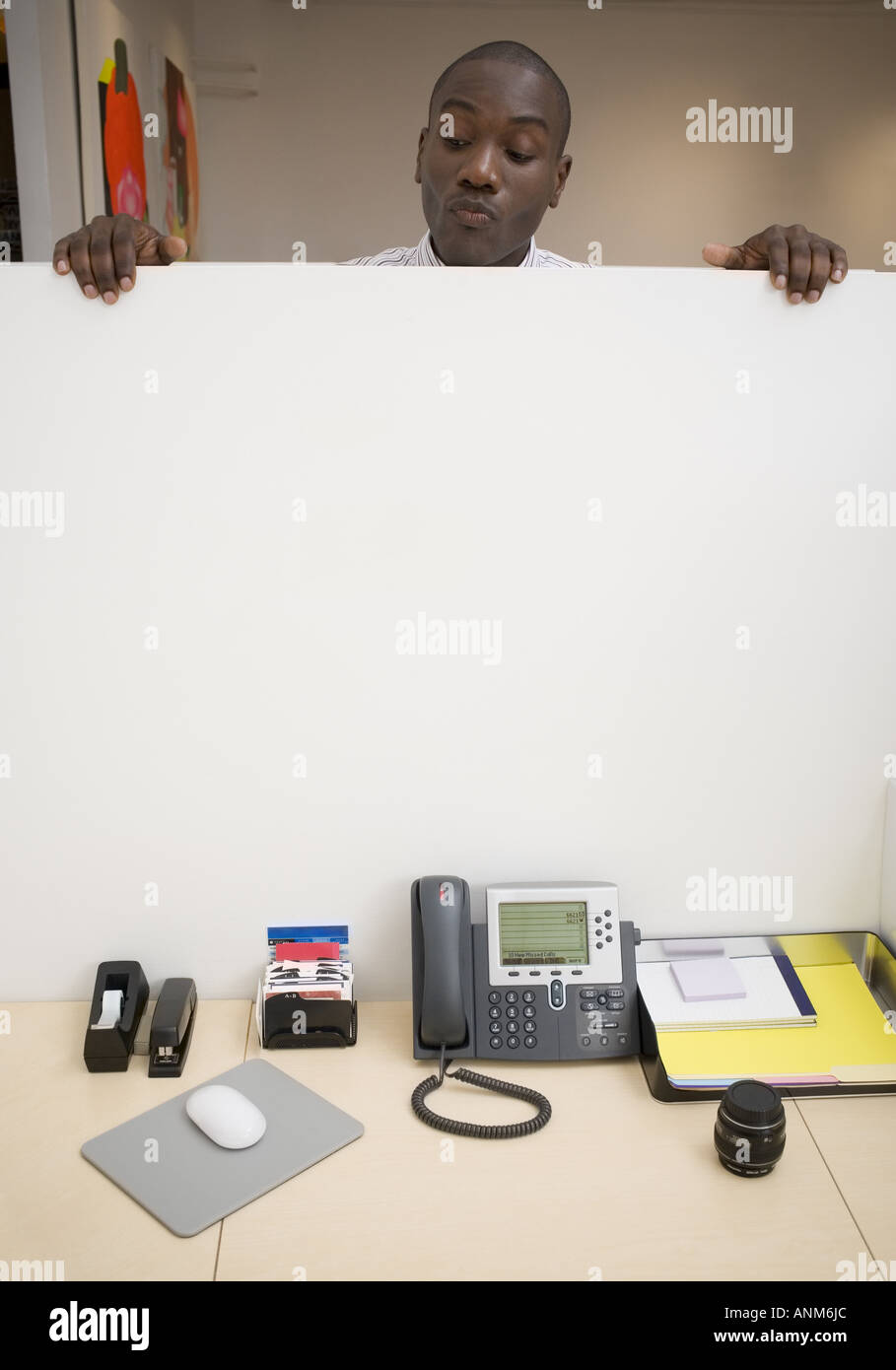 Man peeking over cubicle wall hi-res stock photography and images - Alamy