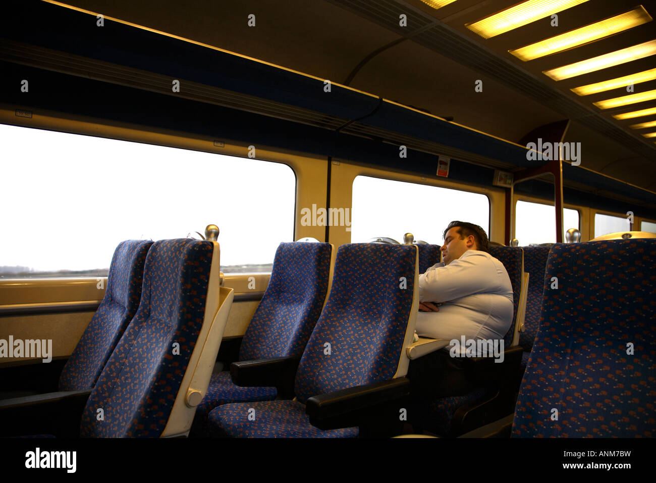 Overweight man sleeping on a train Stock Photo - Alamy