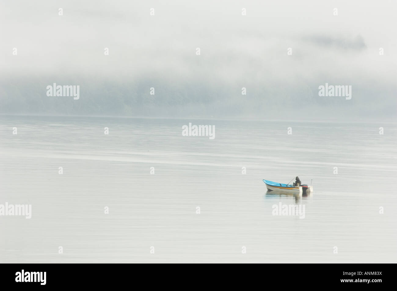 early morning fisherman in fishing boat fog on water Stock Photo - Alamy