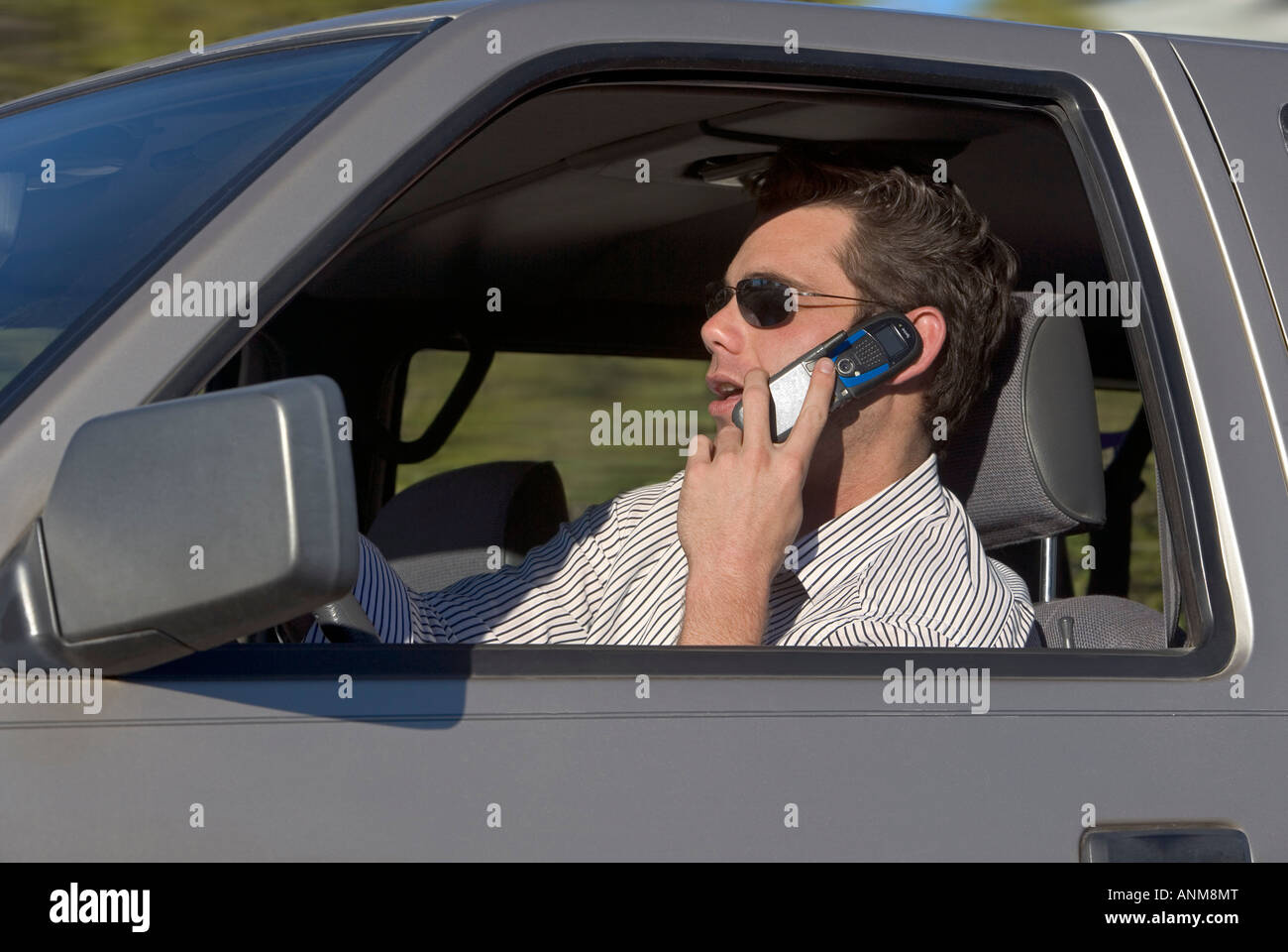 A man talking on a cell phone while driving Stock Photo - Alamy