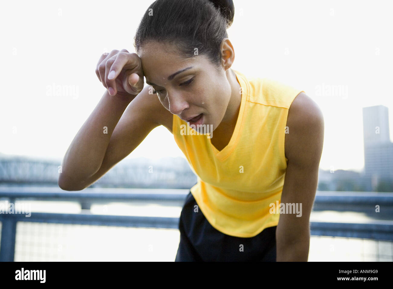 Woman wiping sweat from forehead hi-res stock photography and images ...