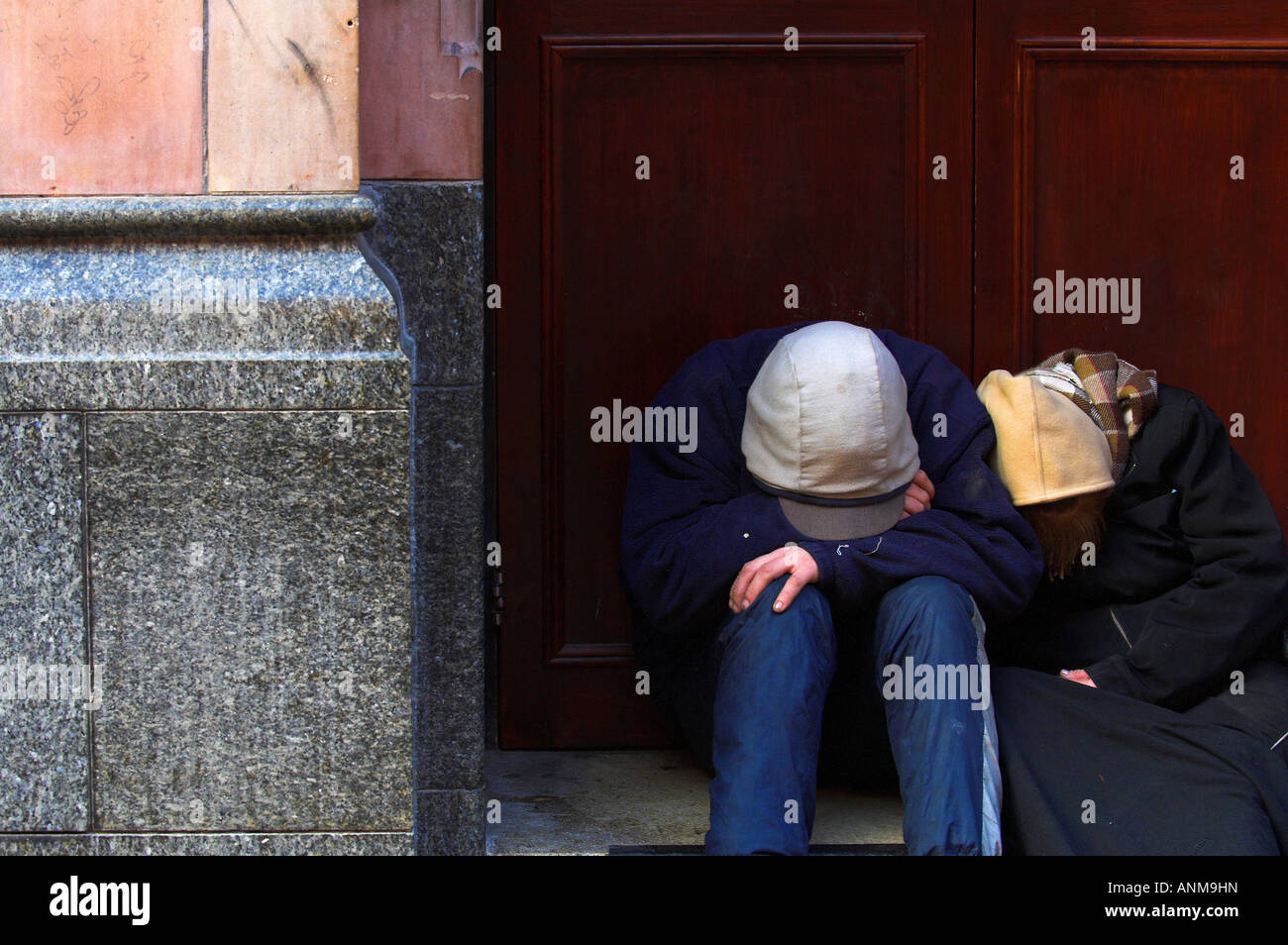 Two young homeless people comfort each other in doorway Stock Photo - Alamy