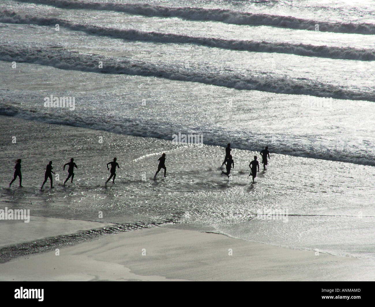 Group of people running seaside sunrise hi-res stock photography and ...