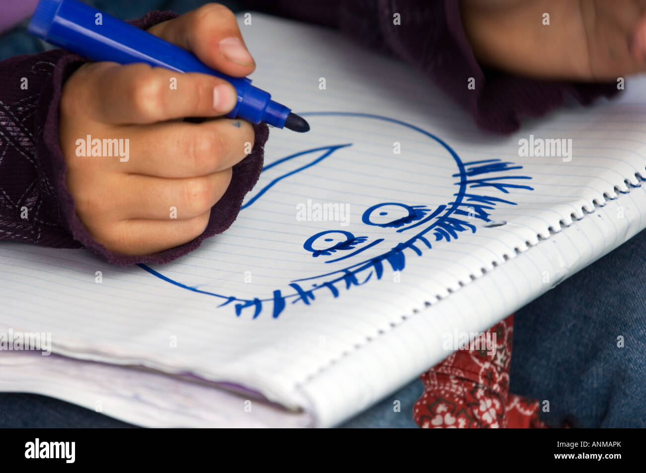 child hand drawing blue felt pen happy face on note pad Stock Photo - Alamy