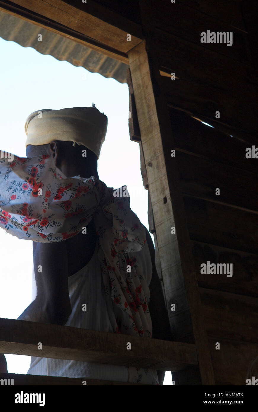 Turkana man sitting in window robe flowing with back to camera Stock ...