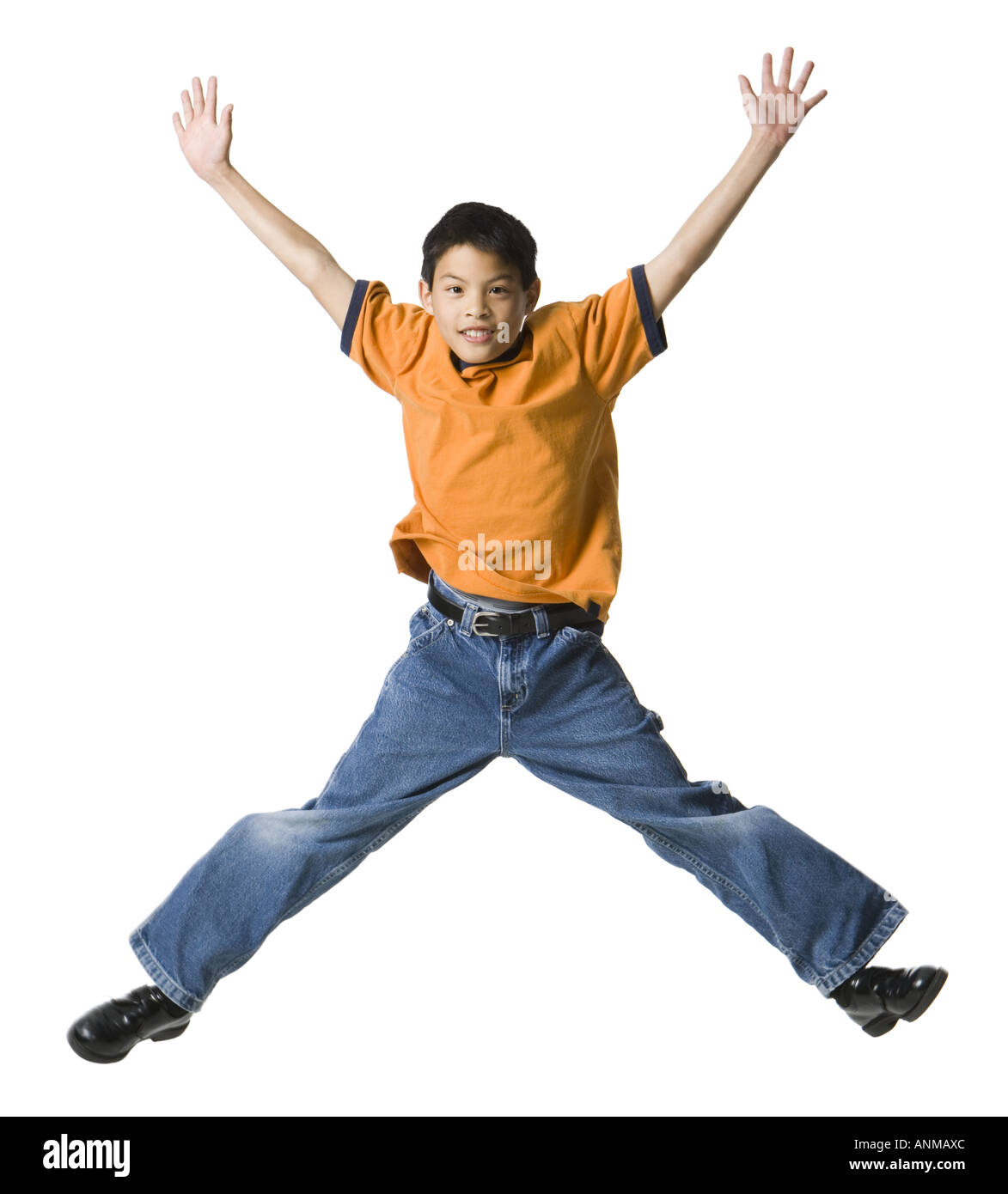 Portrait of a boy jumping with his legs apart Stock Photo - Alamy