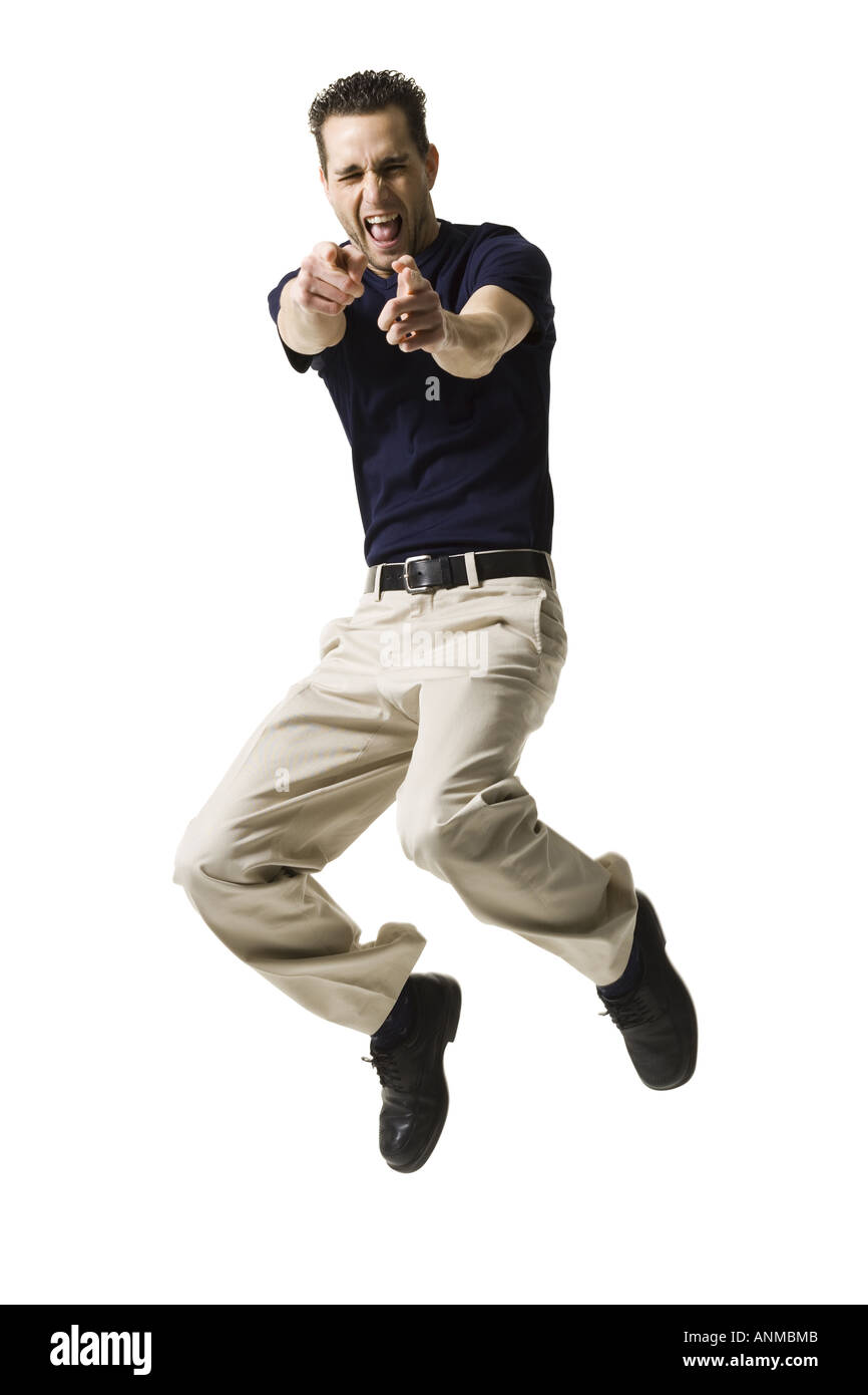 Young man jumping and pointing forward Stock Photo - Alamy