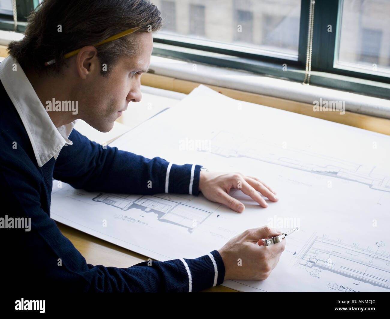 Profile of an architect working on a blueprint Stock Photo - Alamy