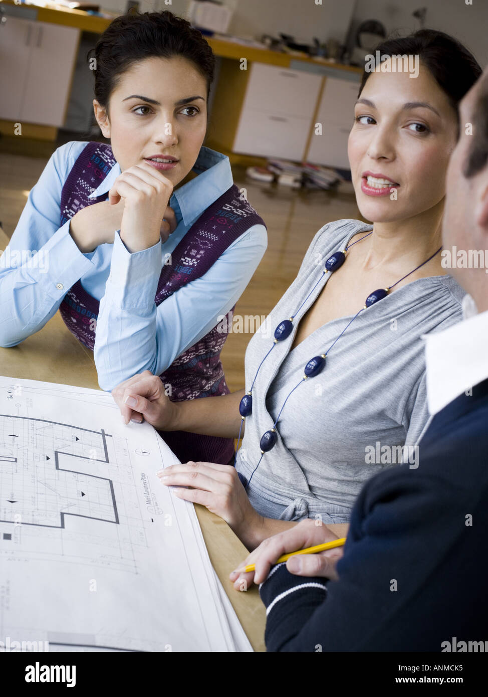 Three architects talking Stock Photo - Alamy