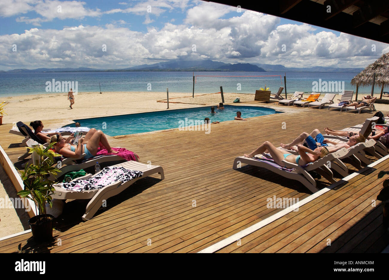 Tourists and locals relax by the pool on Bounty Island in the Mamanuca ...